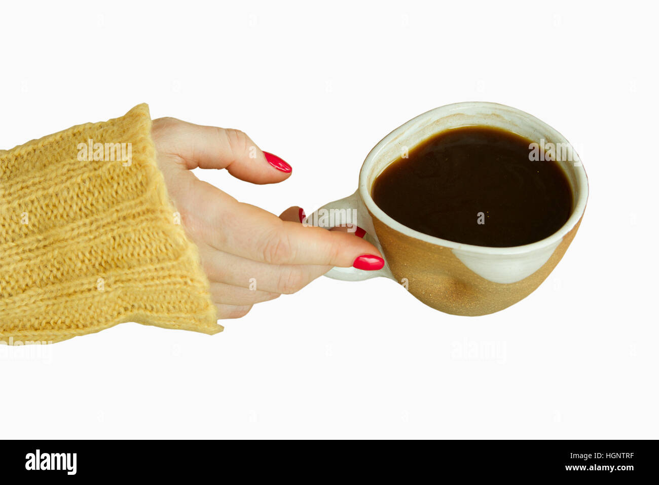 Woman’s hand with red manicure is going to take cup of coffee on white ...