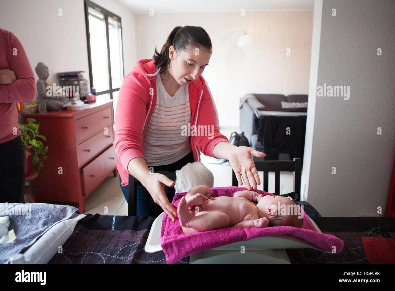 Midwife newborn baby weighing scales hi-res stock photography and ...