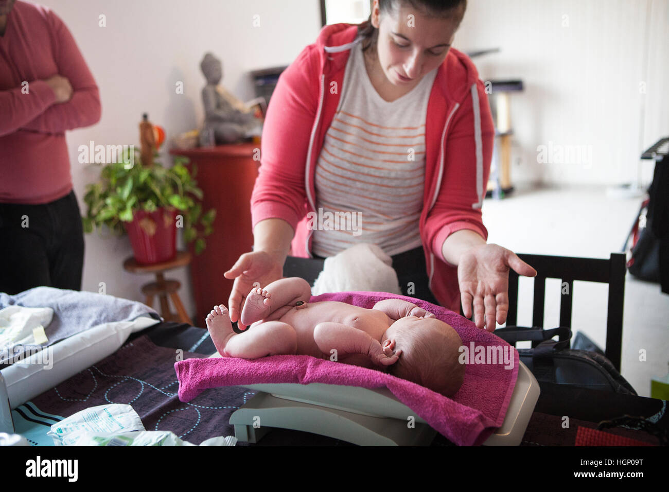 Midwife newborn baby weighing scales hi-res stock photography and ...