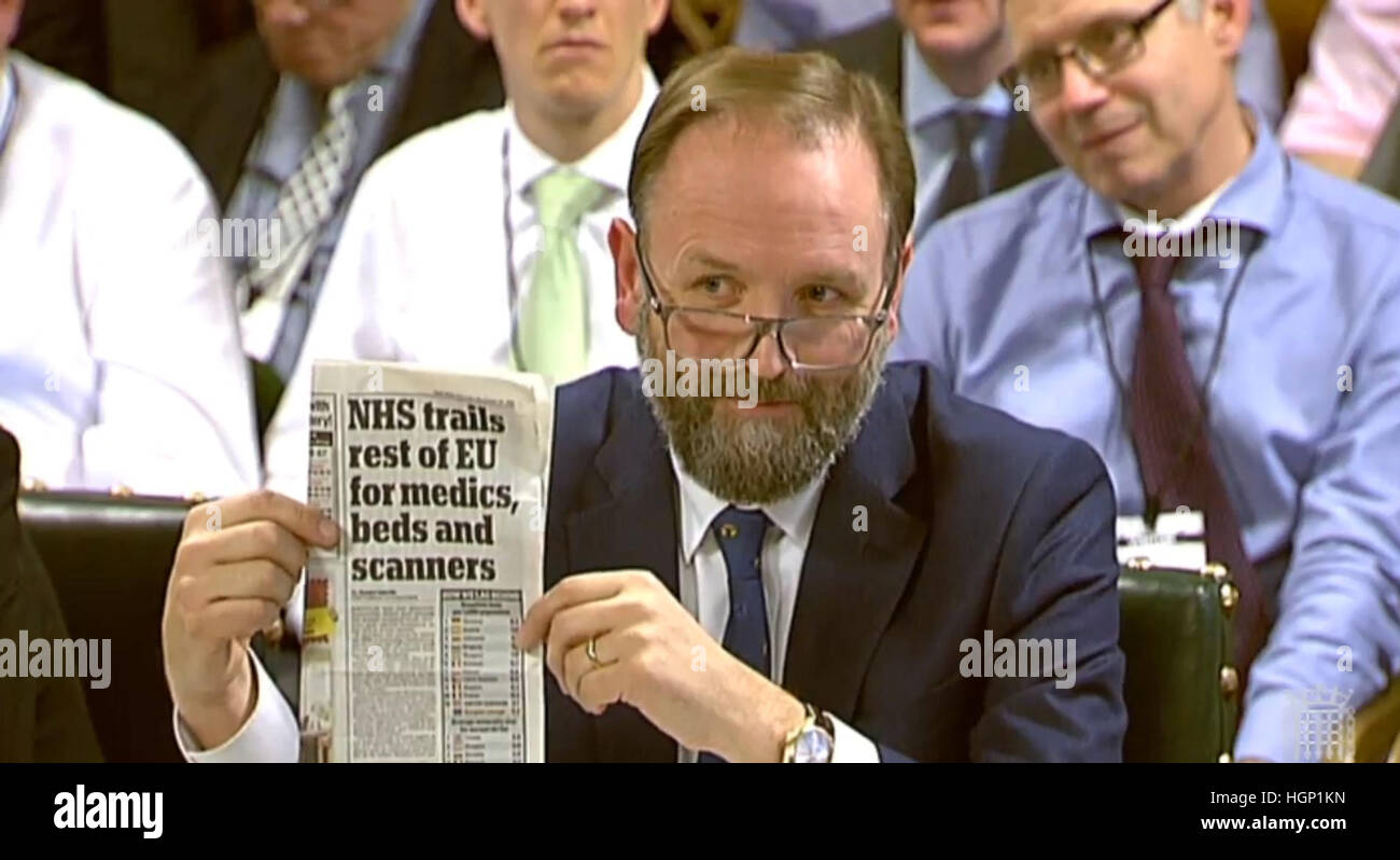 Chief Executive of NHS England Simon Stevens holds up a copy of the ...