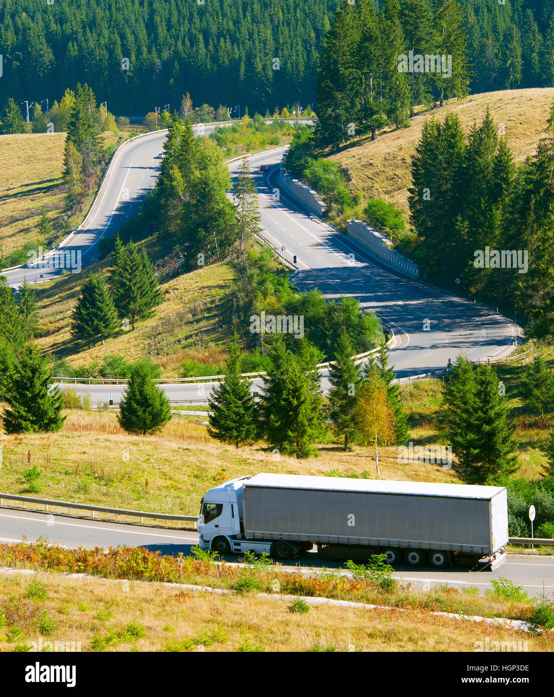 Long vehicle truck on a curve mountains road Stock Photo - Alamy