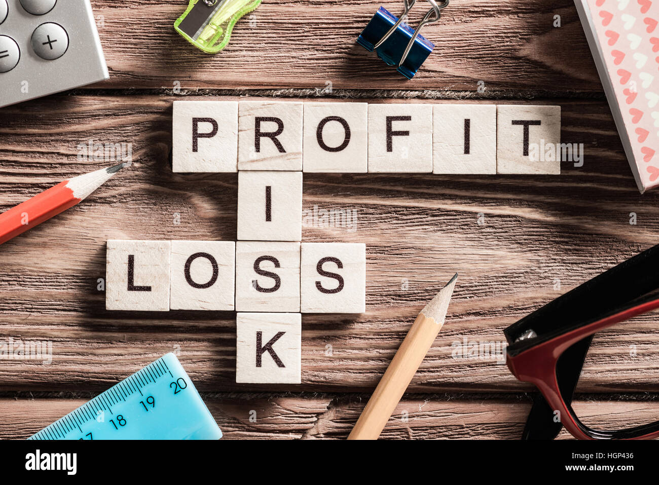 Profit loss and risk words on workplace collected of wooden cubes Stock ...