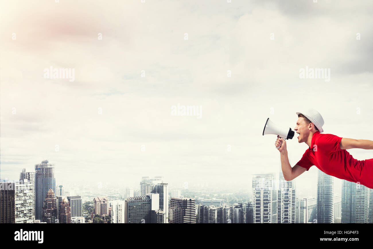 Guy screaming in loudspeaker Stock Photo - Alamy