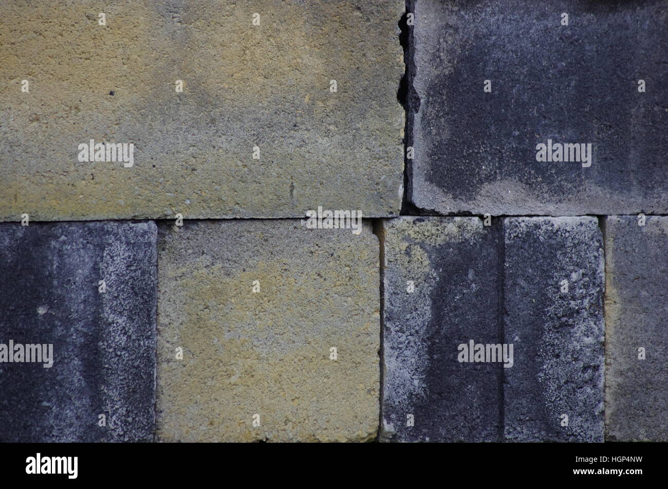 Dark and light gray concrete blocks and bricks in a stacked pattern ...