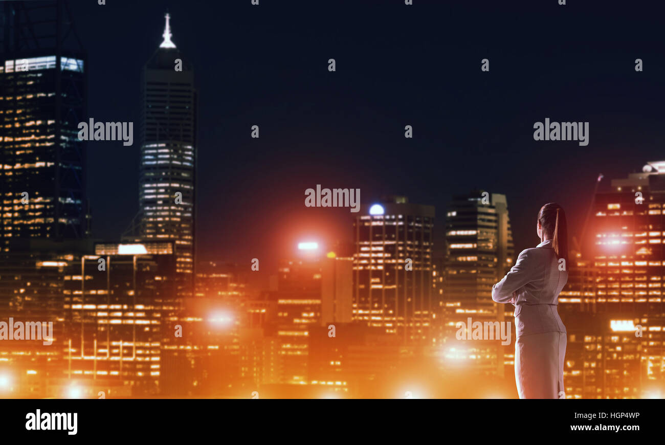 Woman looking at night city Stock Photo - Alamy