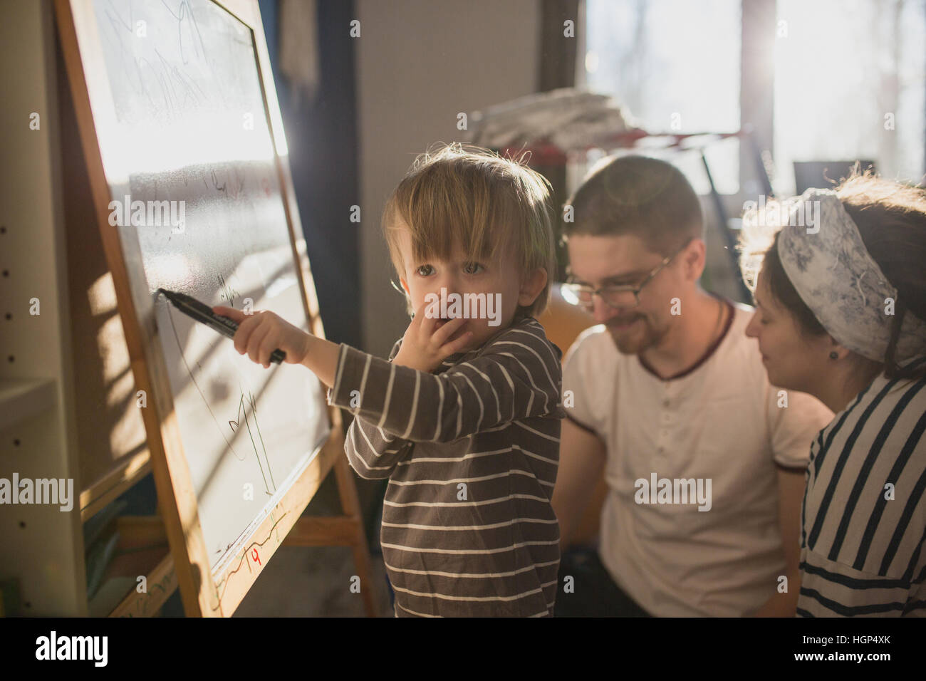 Dad and son together paint on Easel. Real interior, toning soft focus ...