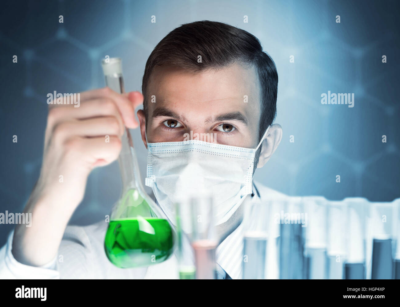 Portrait of concentrated male scientist working with reagents in ...