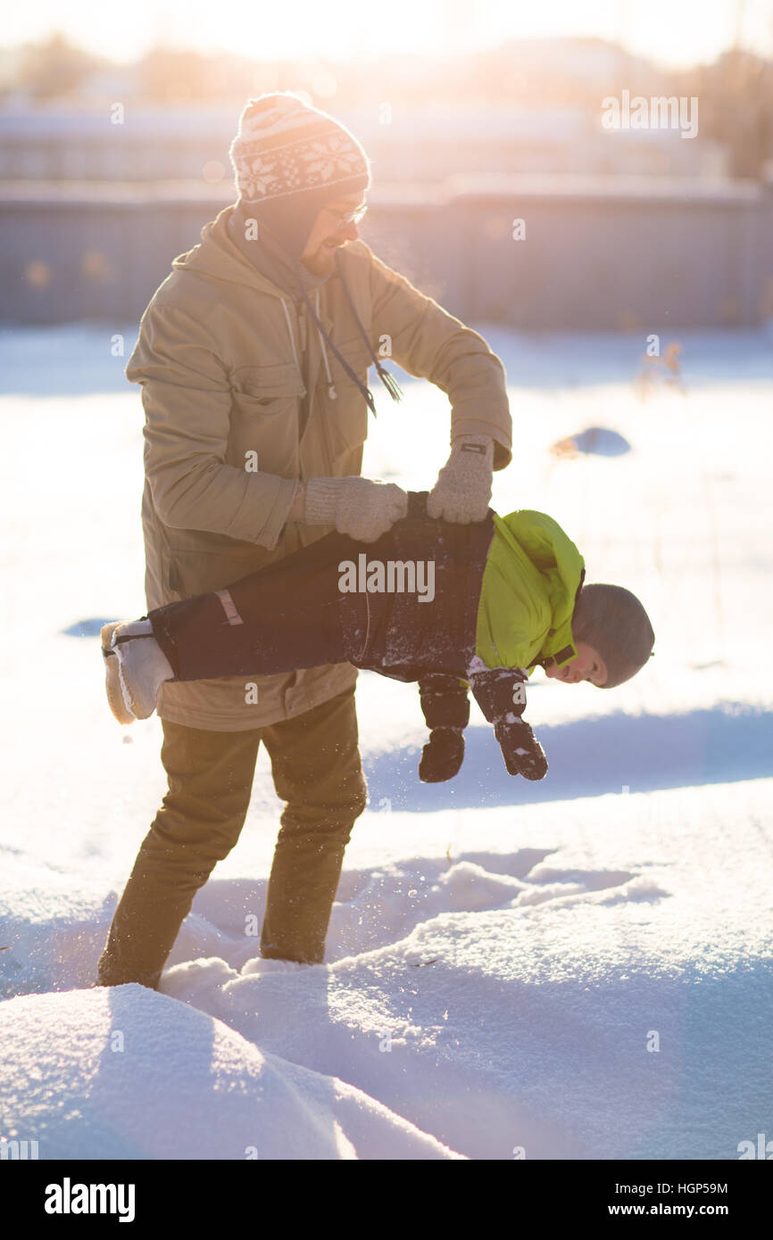 happy family, Dad and son plaing in snow winter , the sun's rays Stock ...