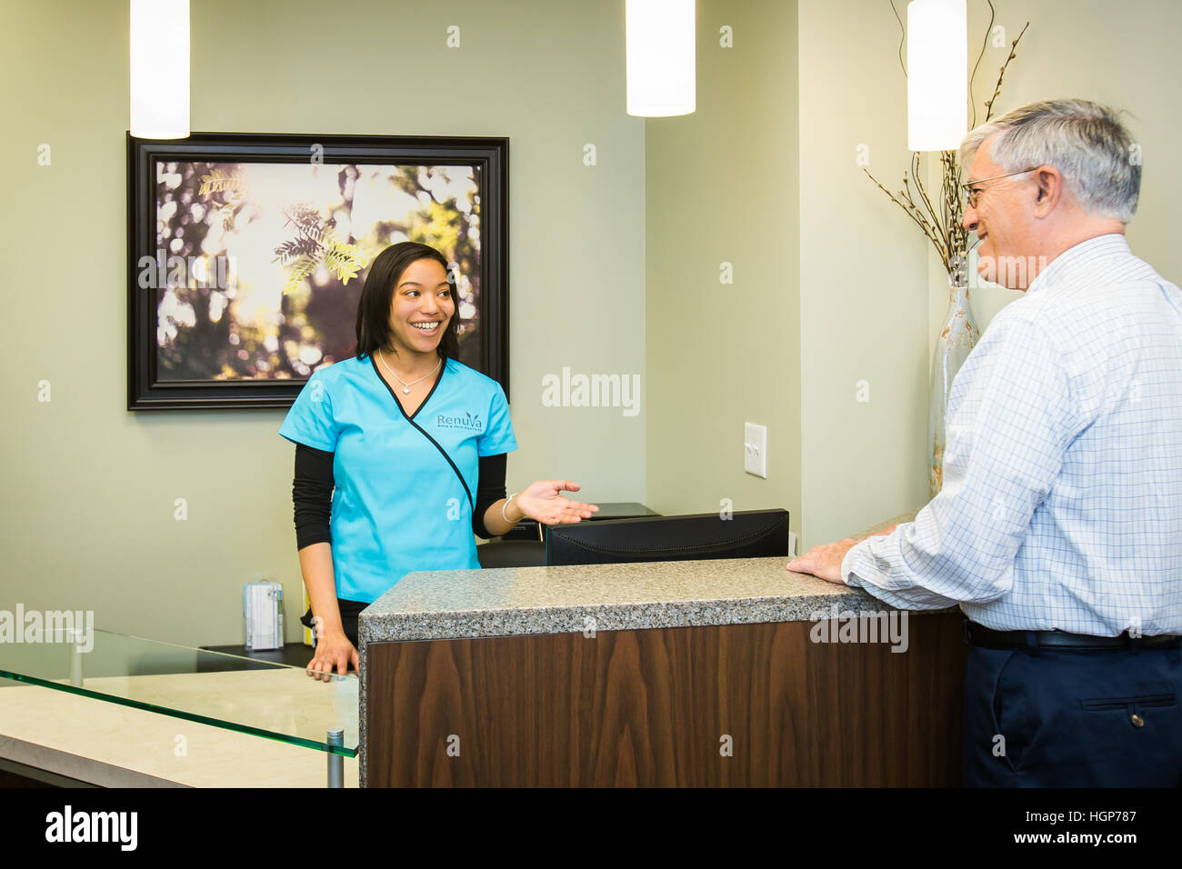 Patient checking into doctor's office Stock Photo - Alamy