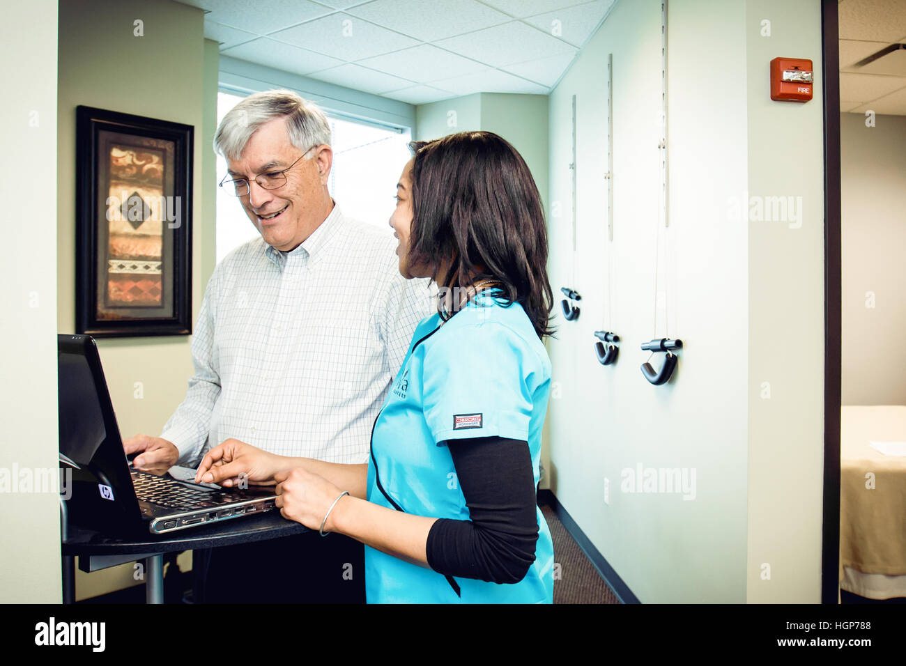 Patient checking into doctor's office Stock Photo - Alamy