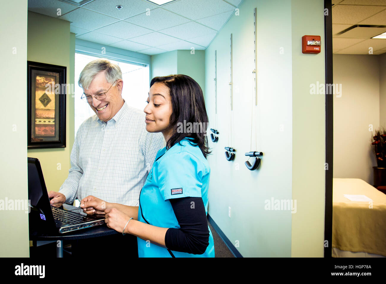 Patient checking into doctor's office Stock Photo - Alamy