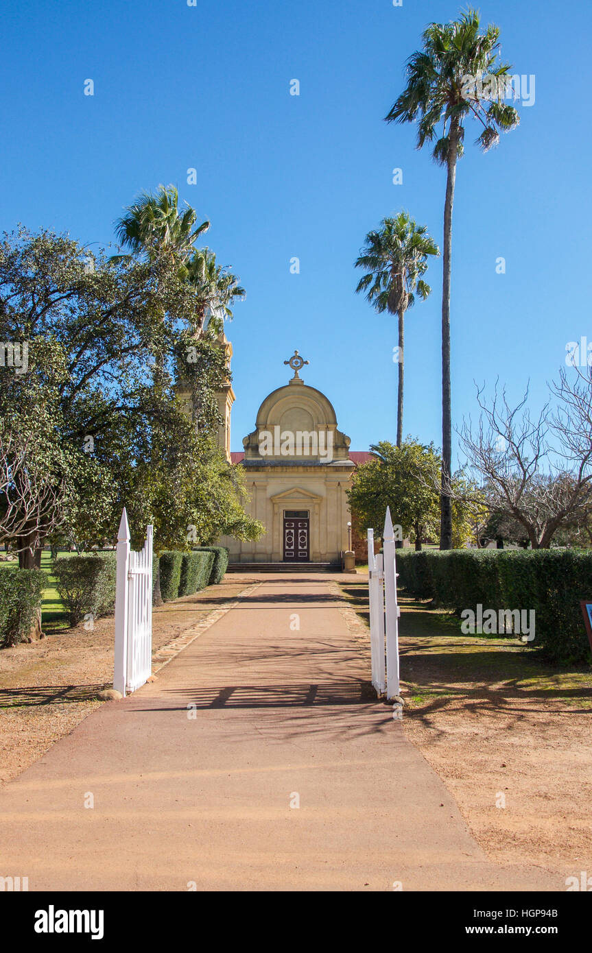 Front view of the Abbey Church of Holy Trinity with tropical palm trees ...