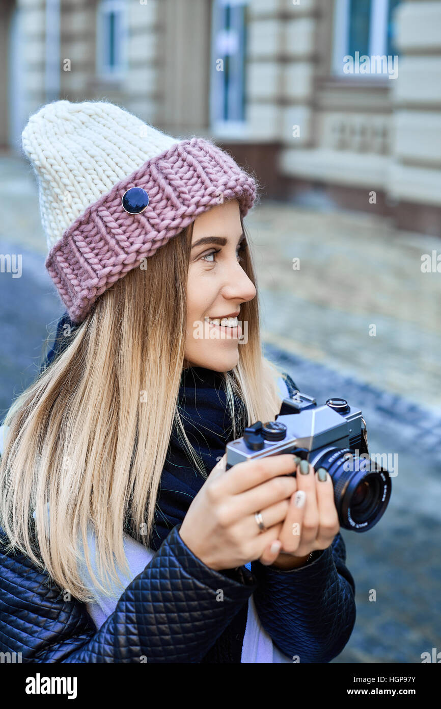 Beautiful girl photographer photographing the old town with retro ...