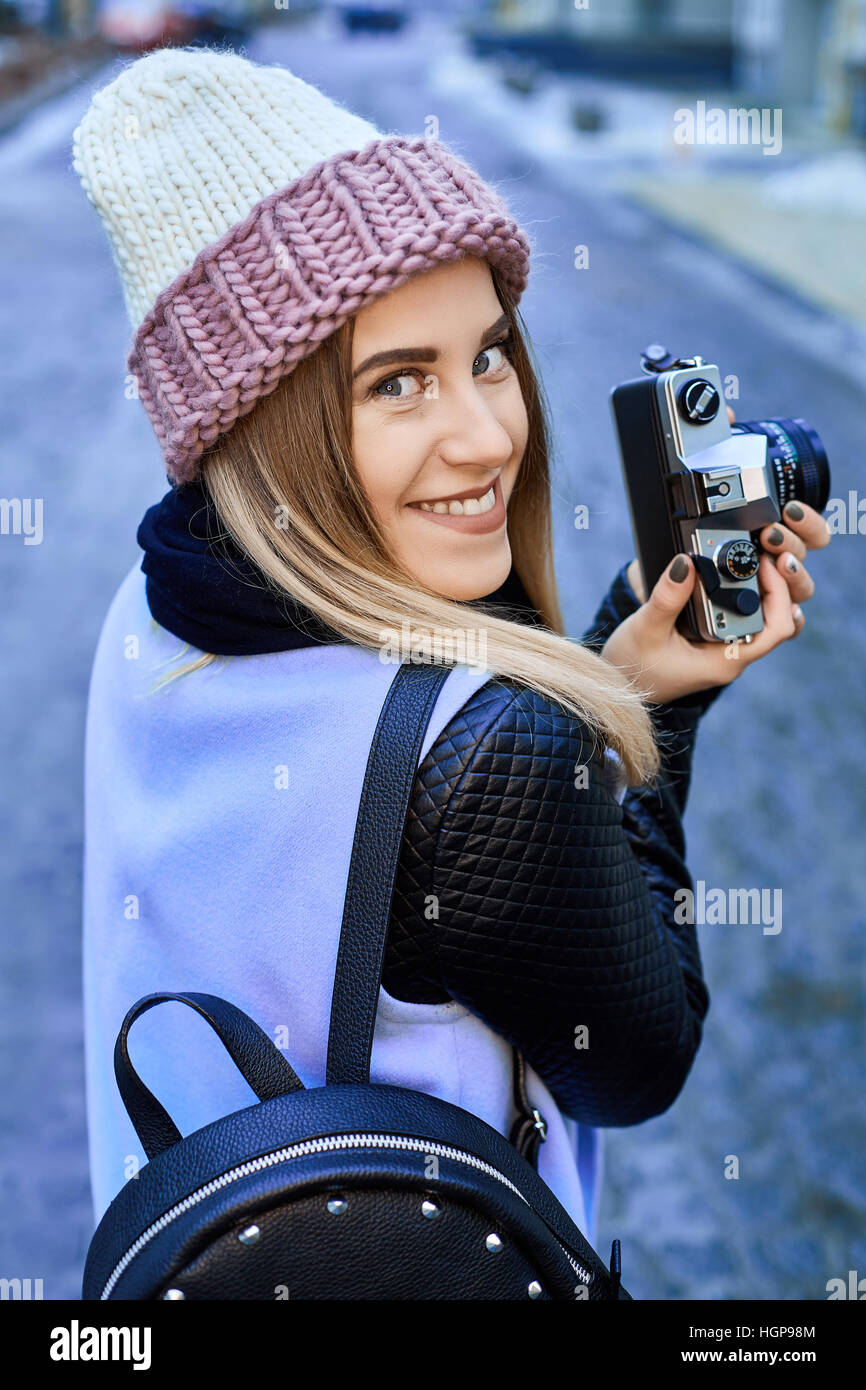 Beautiful girl photographer photographing the old town with retro ...