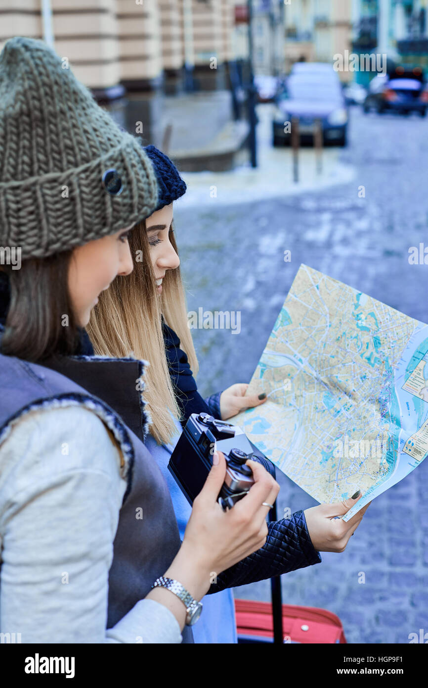 Two friends tourists choose attractions on the map Stock Photo - Alamy