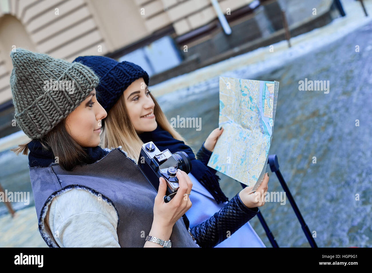 Two friends tourists choose attractions on the map Stock Photo - Alamy