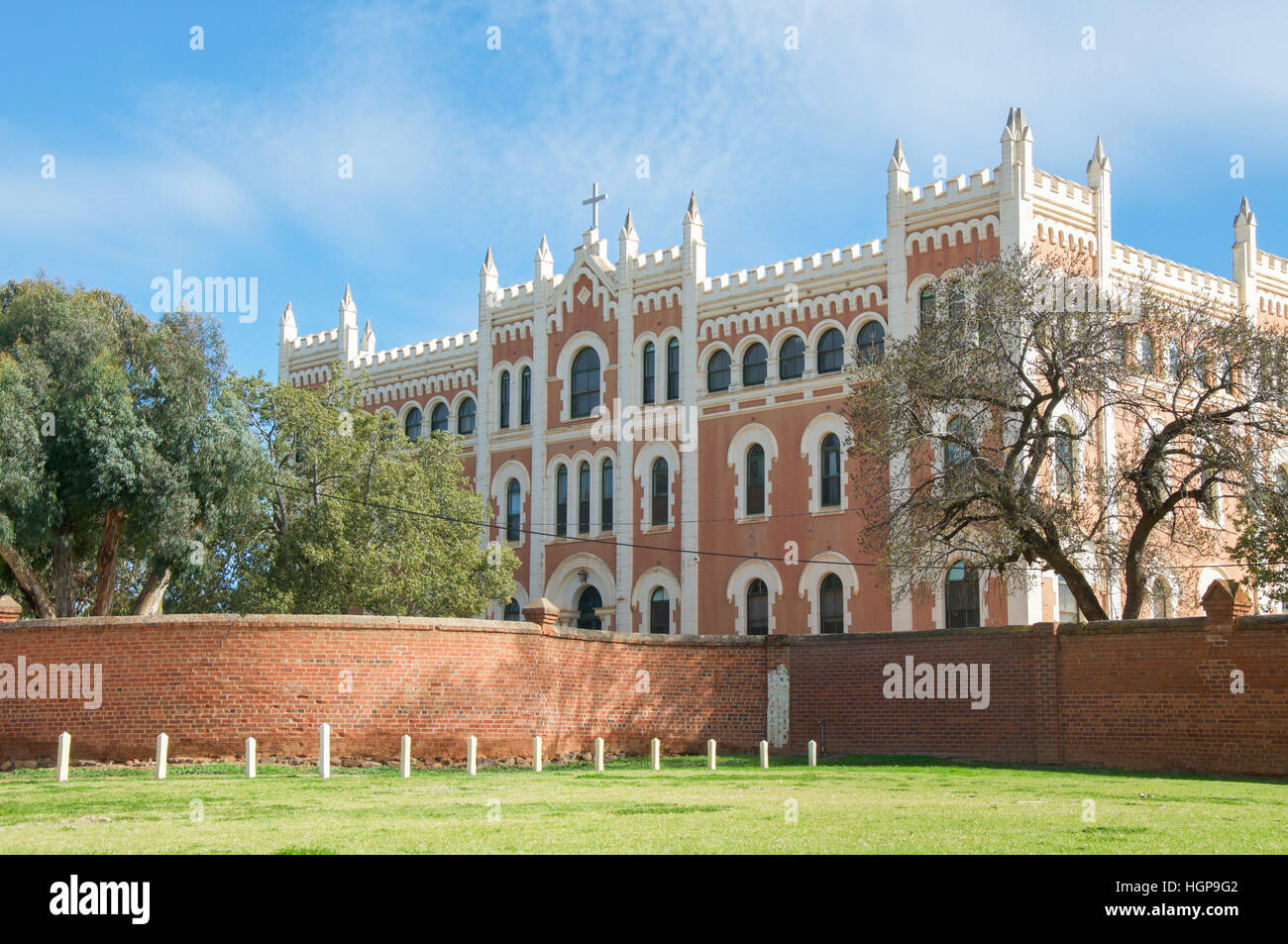 Grandiose gothic and castle-like St. Ildephonsus College with cross and ...