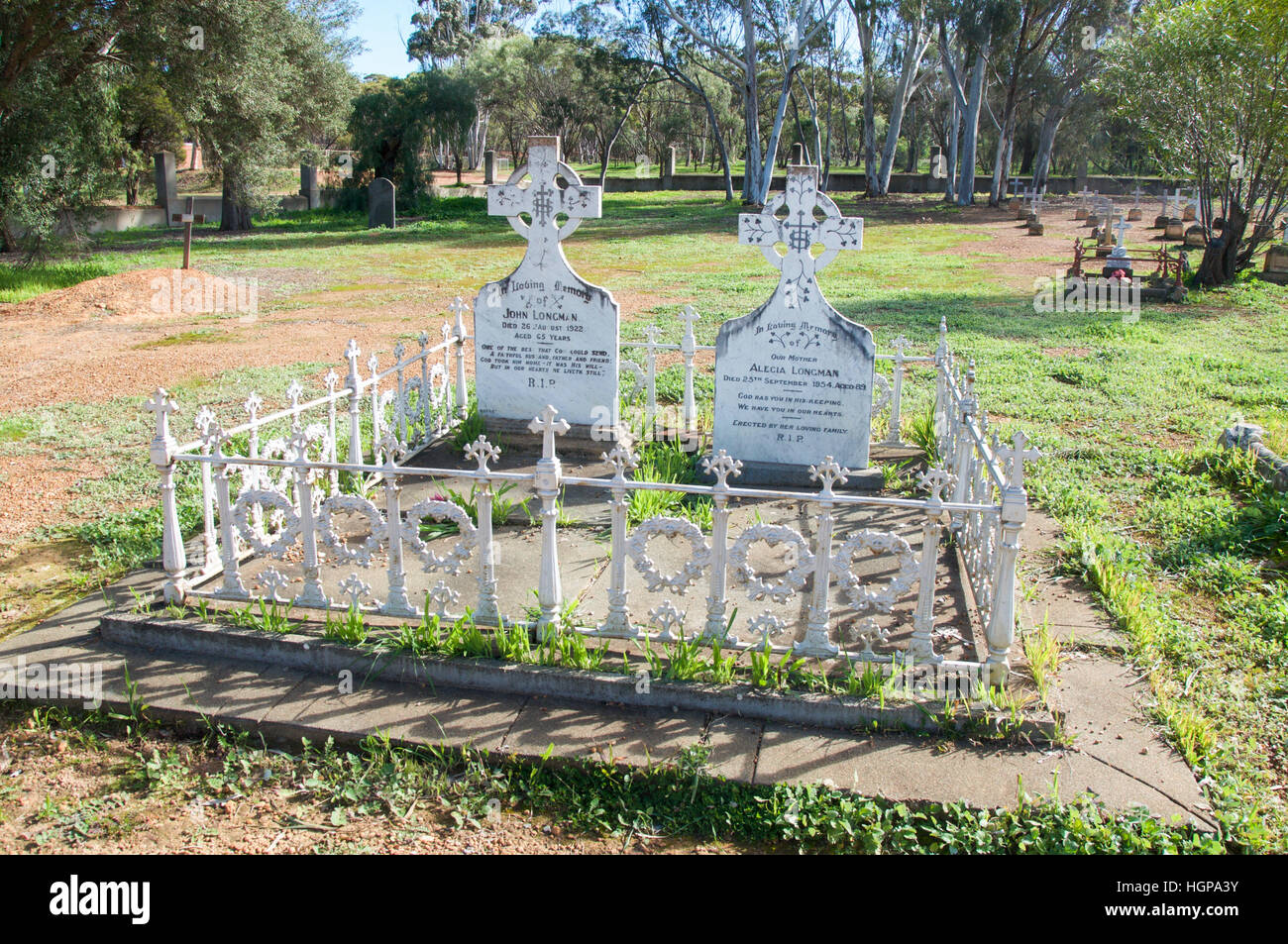 Two headstones enclosed in white fencing in the peaceful cemetery in ...