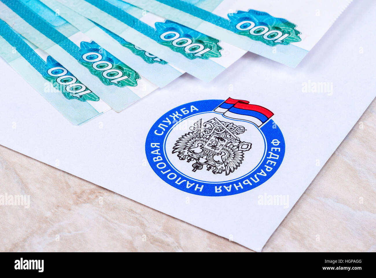 Emblem of the Federal Tax Service of Russia and russian banknotes close ...