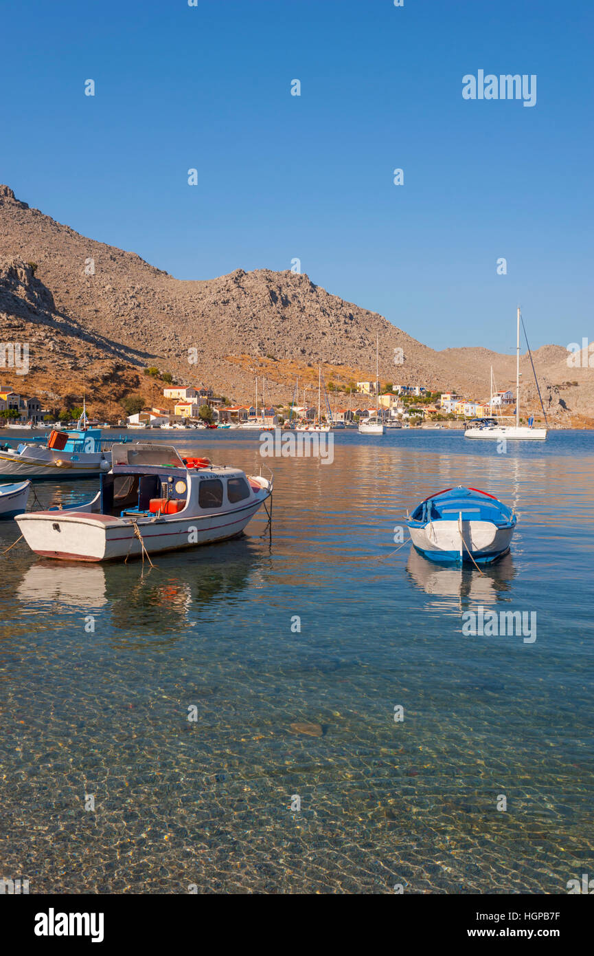 Boats and yachts moored at Pedi bay on the Greek island of Symi Stock ...