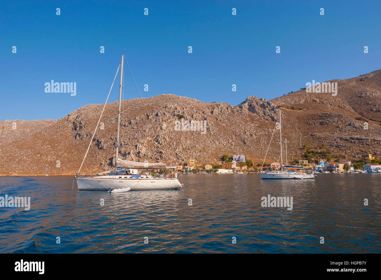Yachts moored in pedi bay on the Greek Island of Symi Stock Photo - Alamy