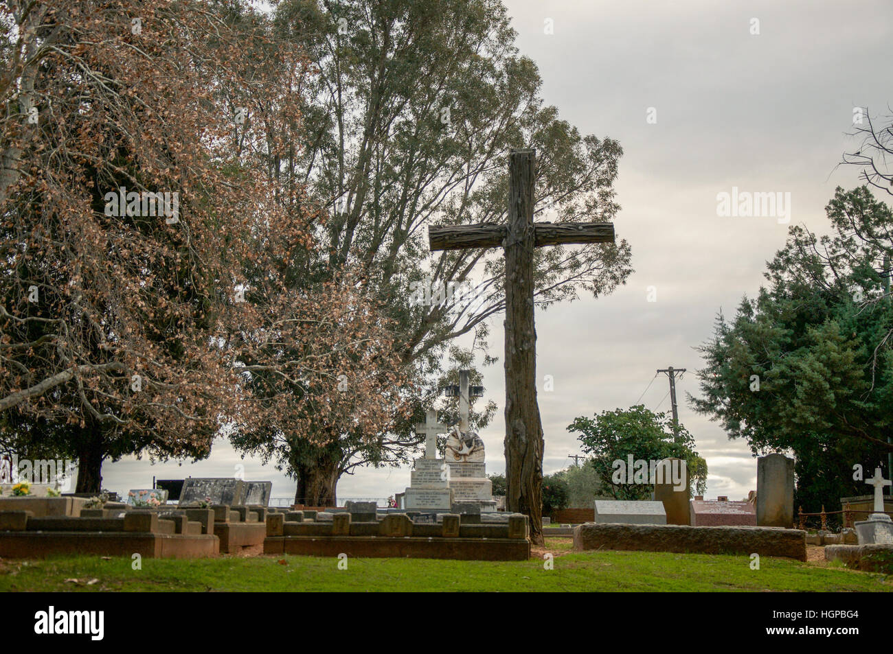 Large wooden cross in the All Saints Church cemetery with head stones ...