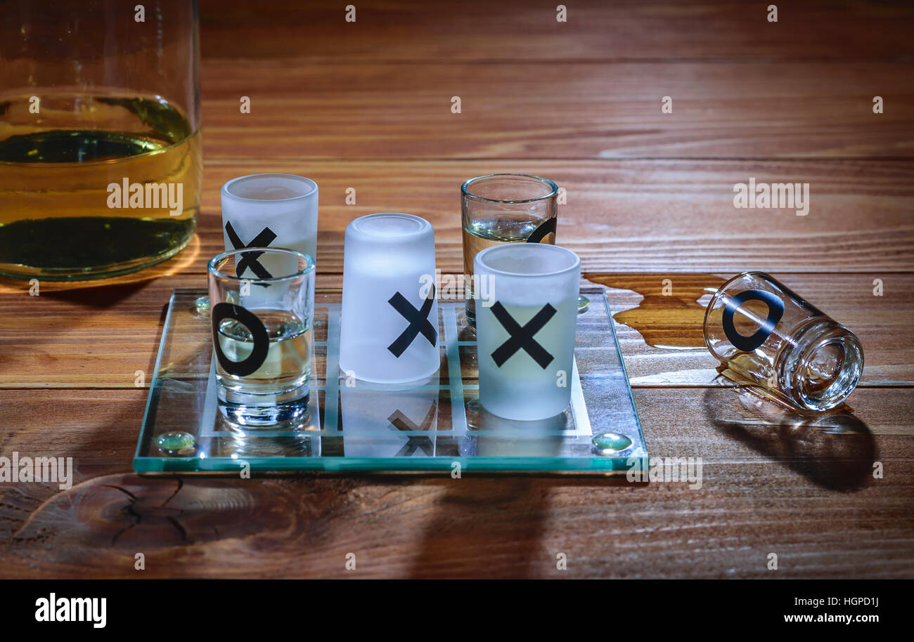 Alcohol wins in xOx game on a wooden table Stock Photo - Alamy