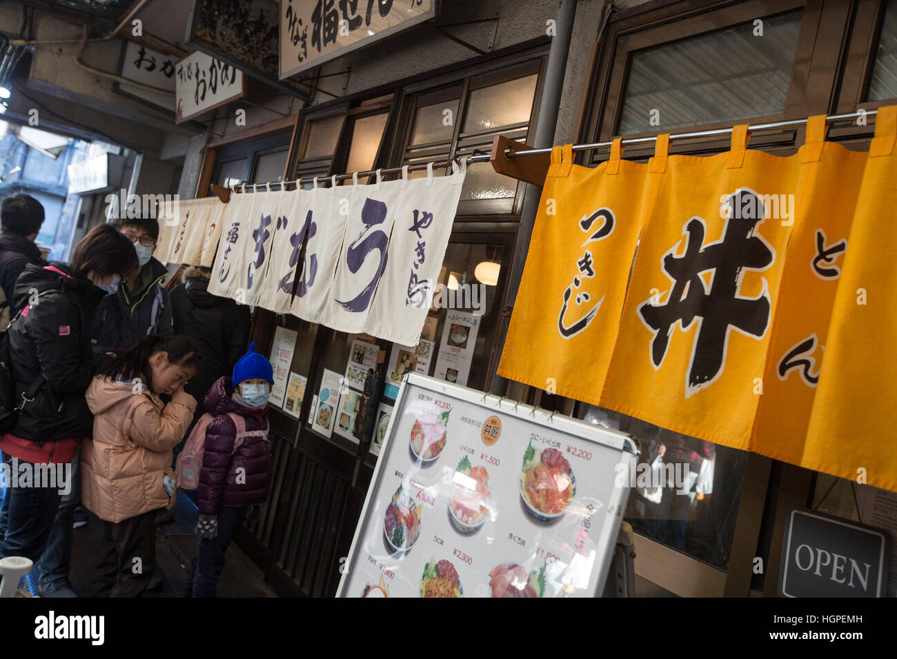 Queuing outside sushi restaurants in the Tsukiji fish market, in Tokyo ...