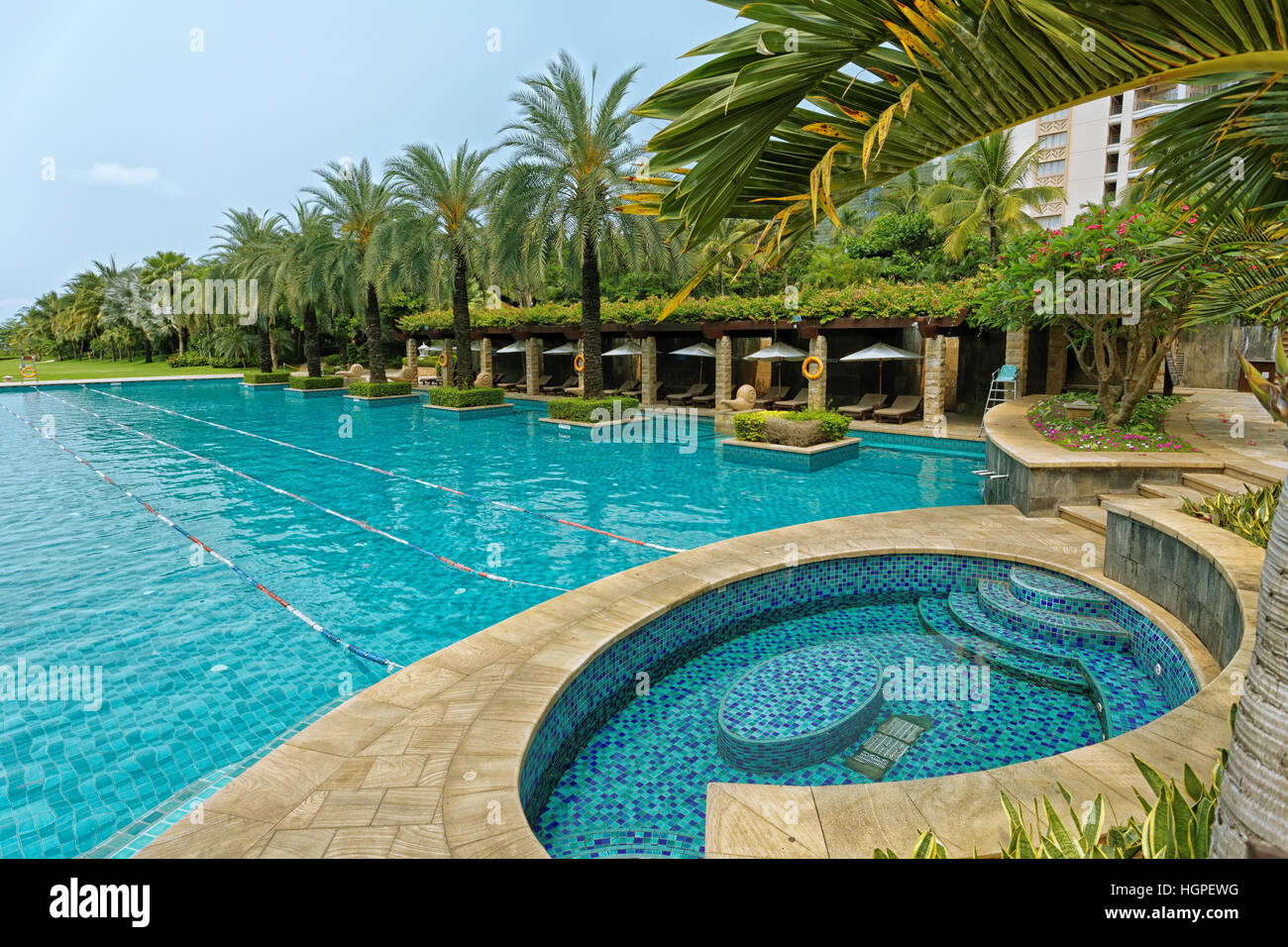 Hotel pool with decorations, steps and trees Stock Photo - Alamy