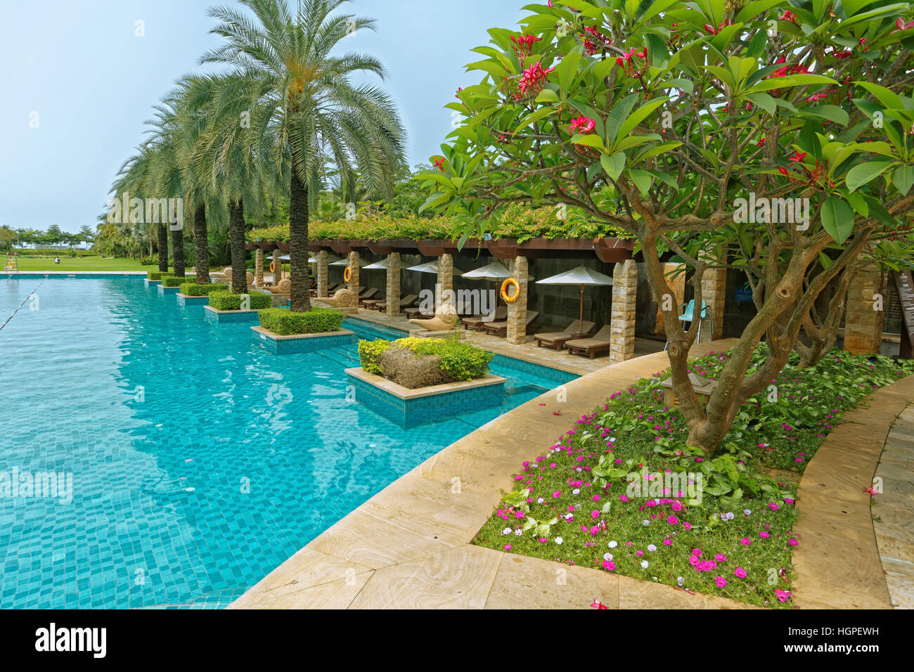 Hotel pool with decorations, steps and trees Stock Photo - Alamy