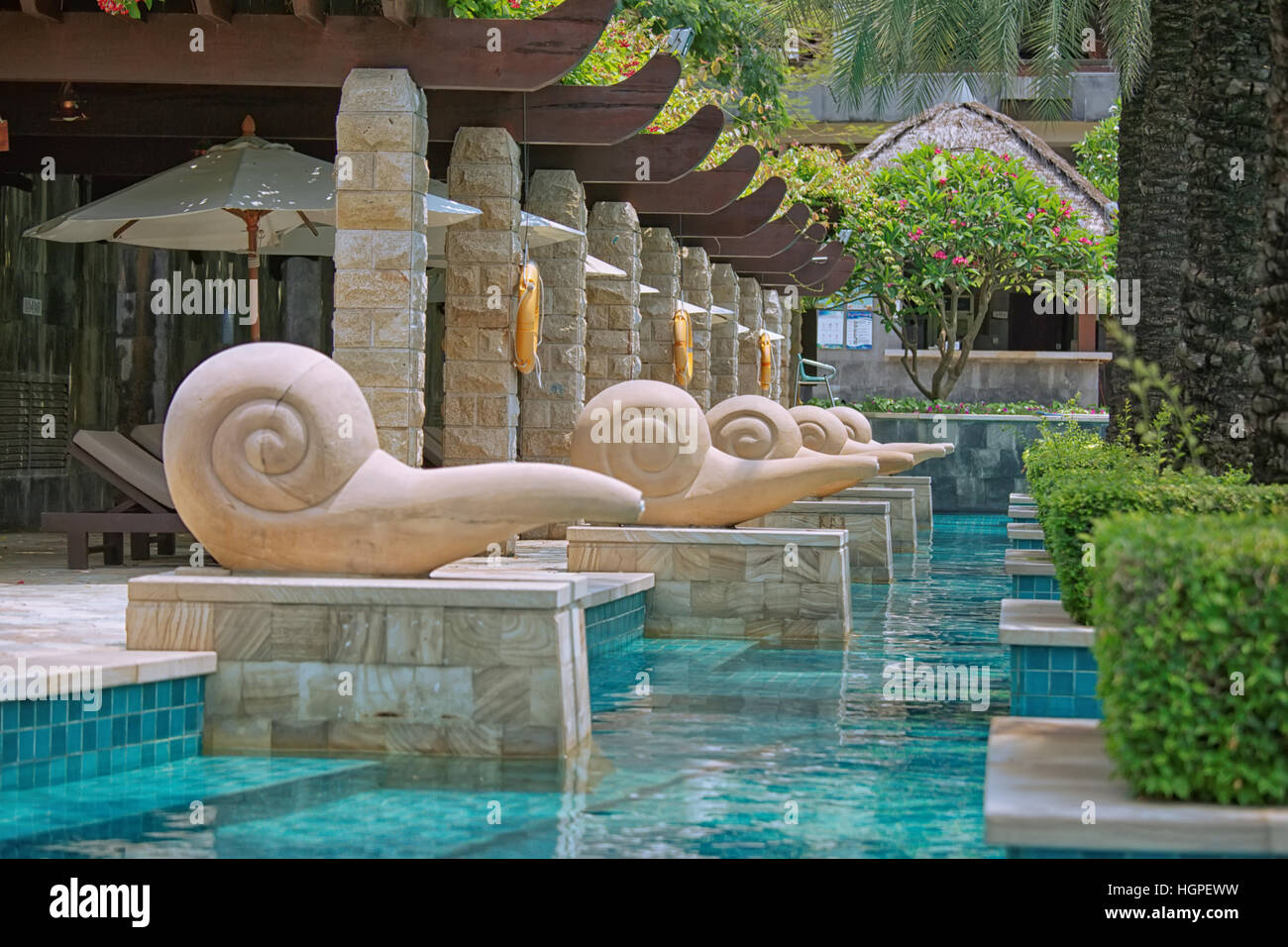 Hotel pool with decorations, steps and trees Stock Photo - Alamy
