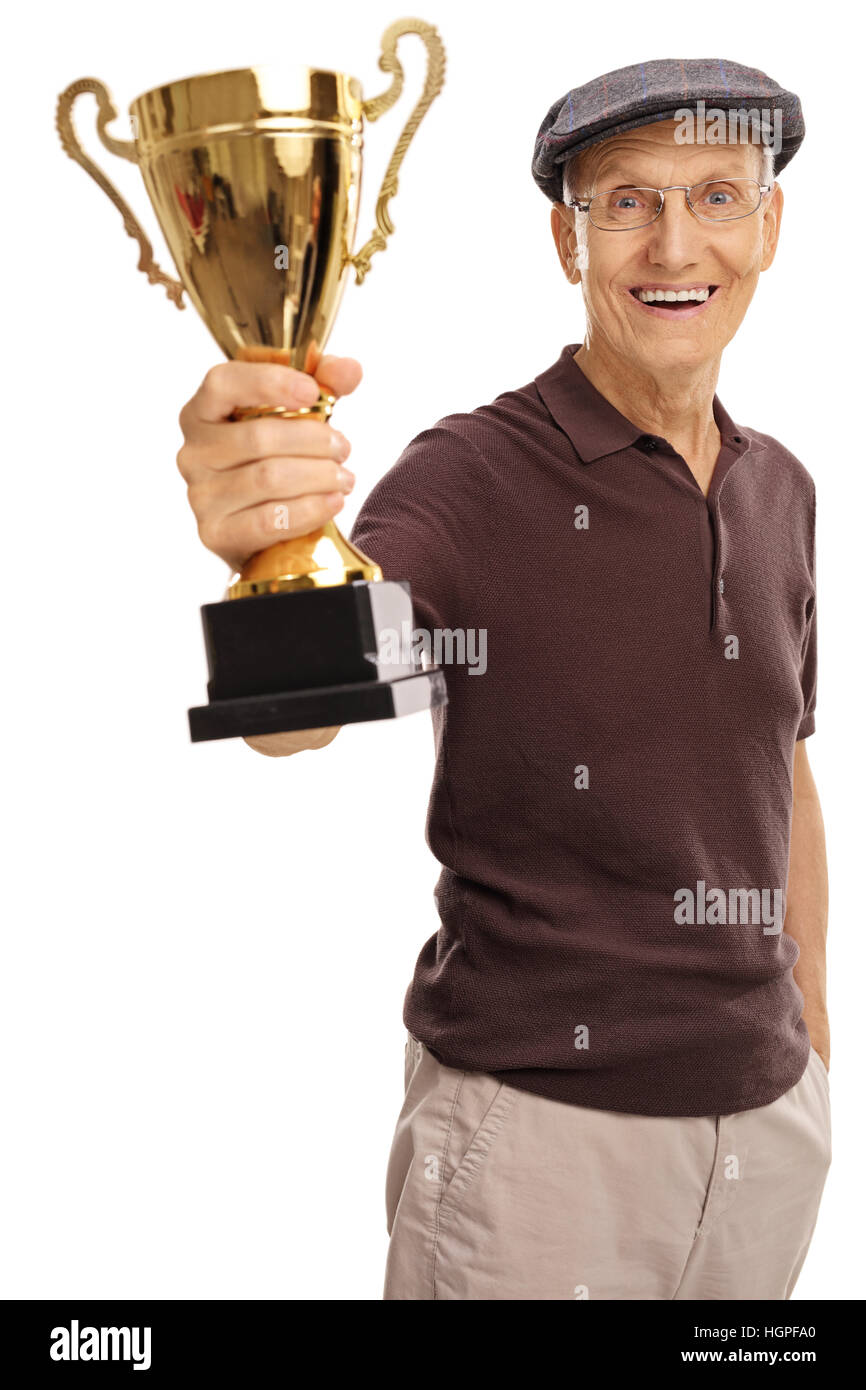 Delighted elderly man holding a golden trophy isolated on white ...