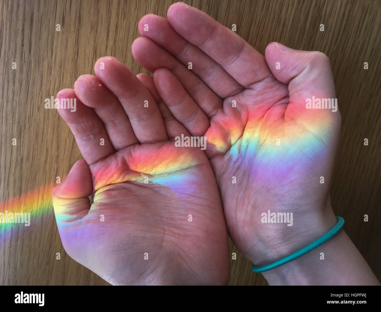 Hand with rainbow Stock Photo - Alamy
