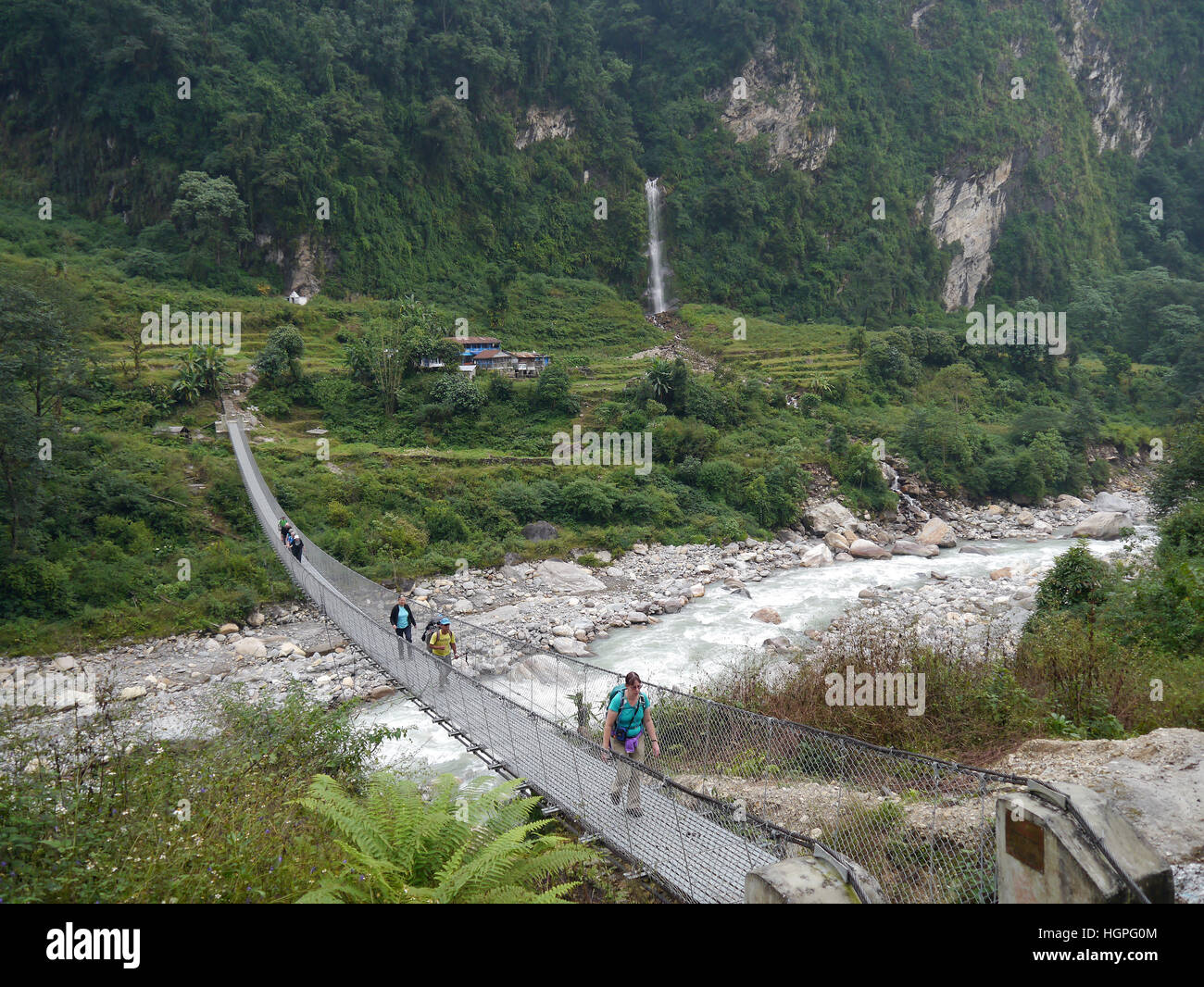 Trekkers Crossing the Suspension Bridge at New Bridge in the Modi Khola ...
