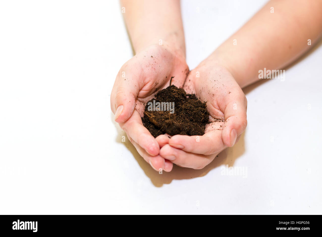 Handful of rich fertile soil in human hands isolated on white ...