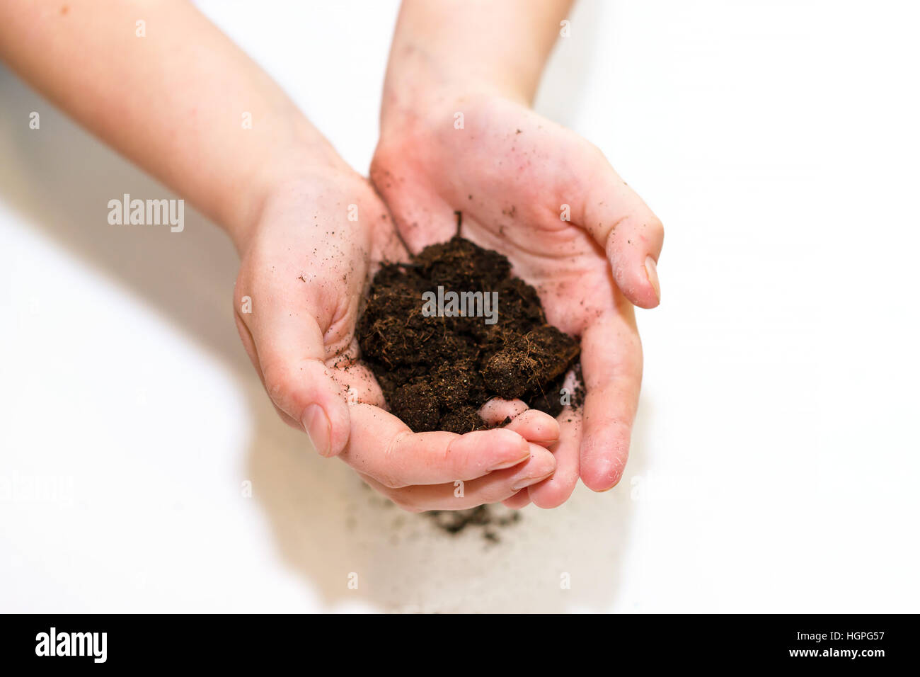 Handful of rich fertile soil in human hands isolated on white ...