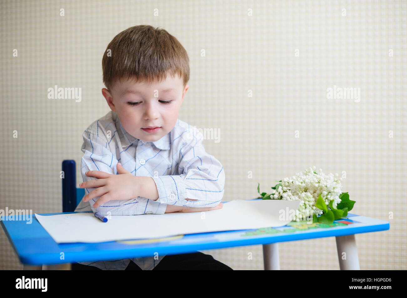 little boy sitting at a desk and listening to the teacher Stock Photo ...