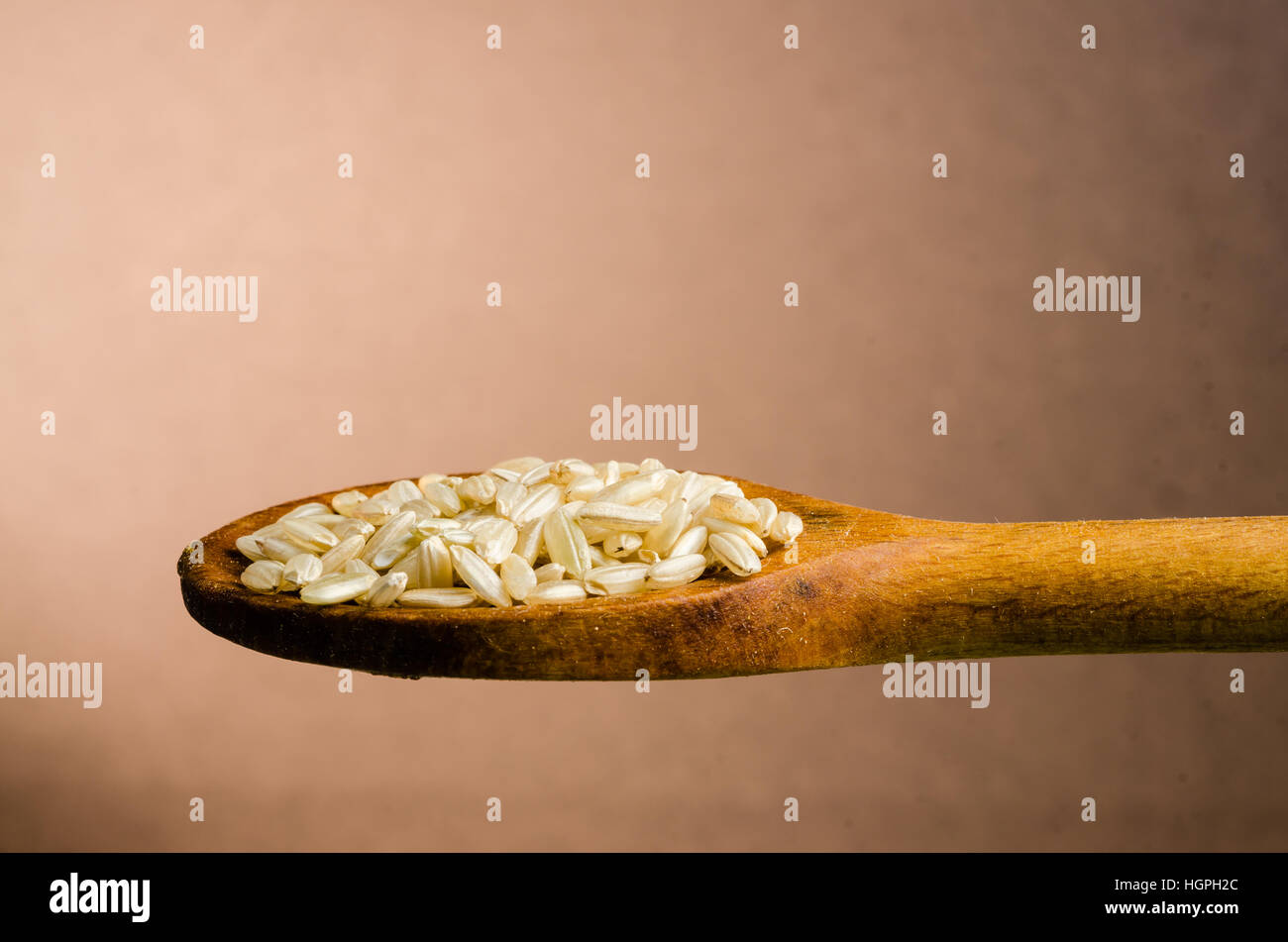 rice in a spoon, close up, color background Stock Photo - Alamy