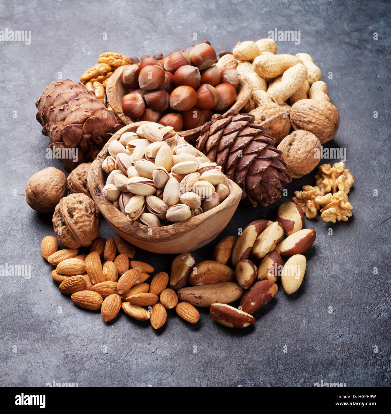 Various nuts on stone table Stock Photo - Alamy