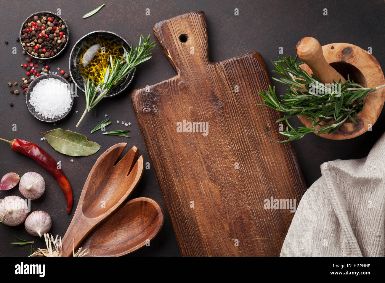 Cooking table with herbs, spices and utensils. Top view with copy space ...