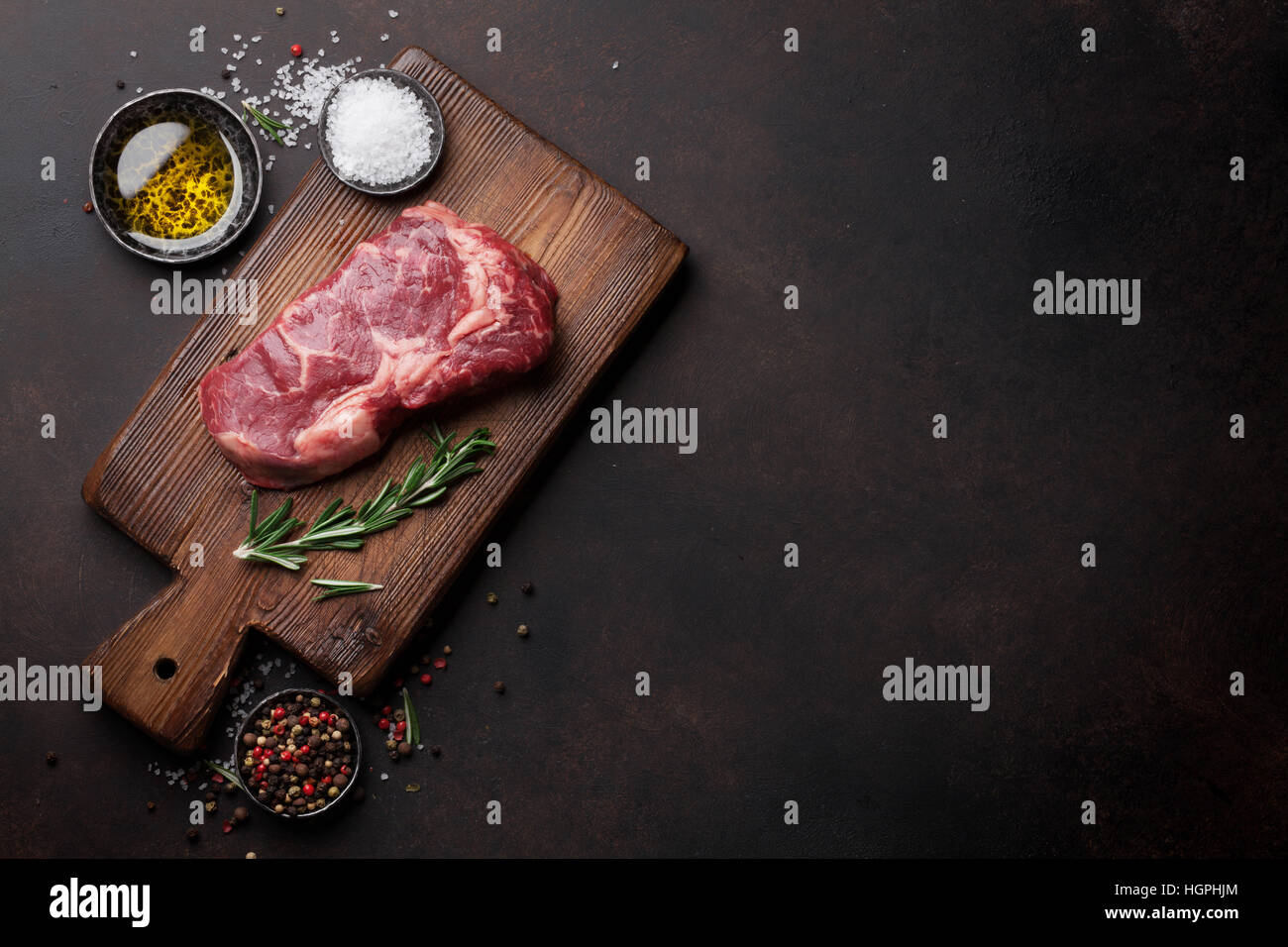 Raw ribeye beef steak cooking with ingredients. Top view with copy ...