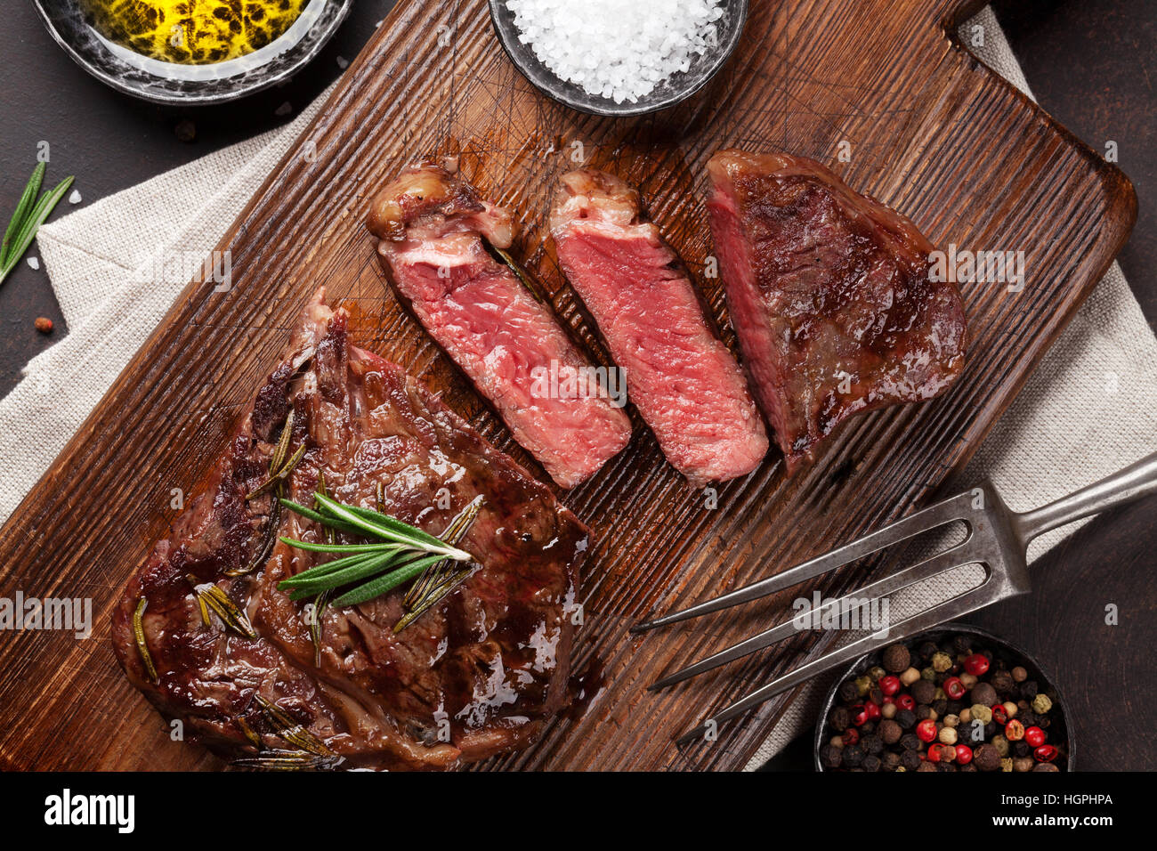 Grilled ribeye beef steak, herbs and spices. Top view Stock Photo - Alamy