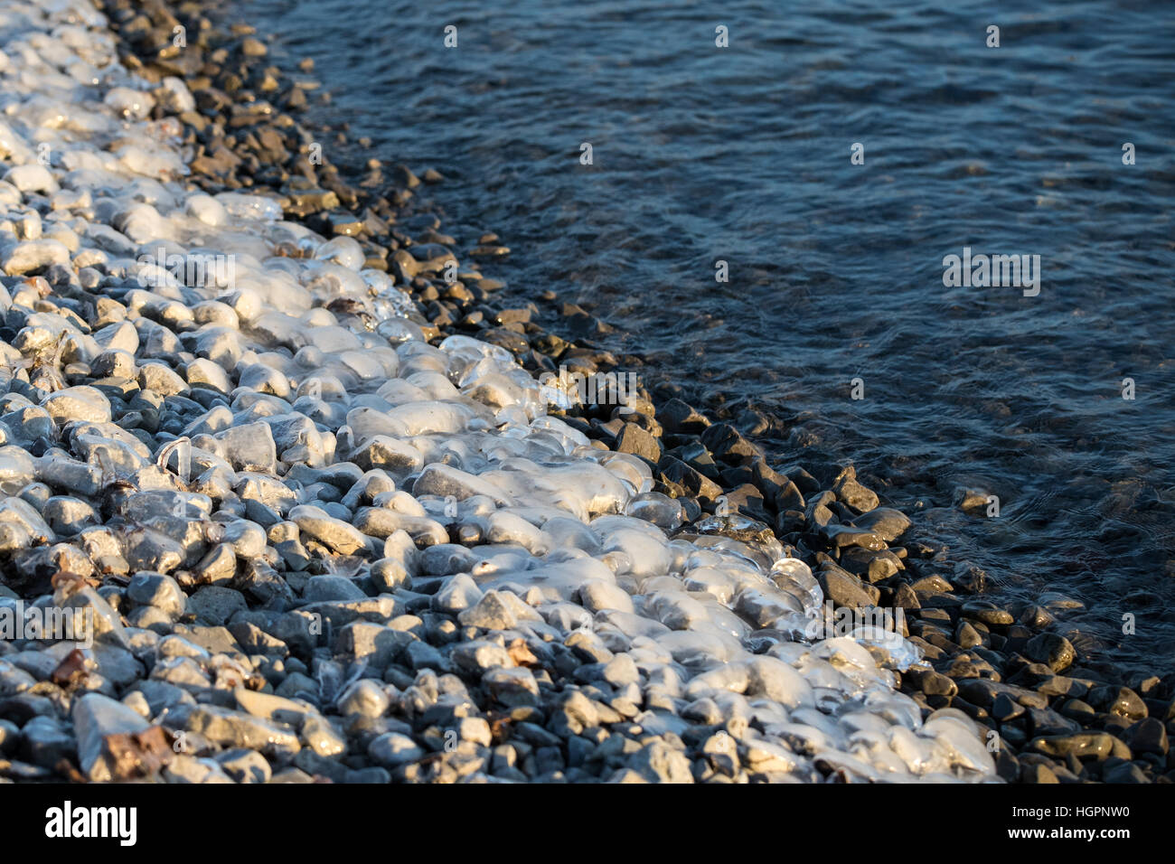 Ice forms on pebbles Stock Photo - Alamy