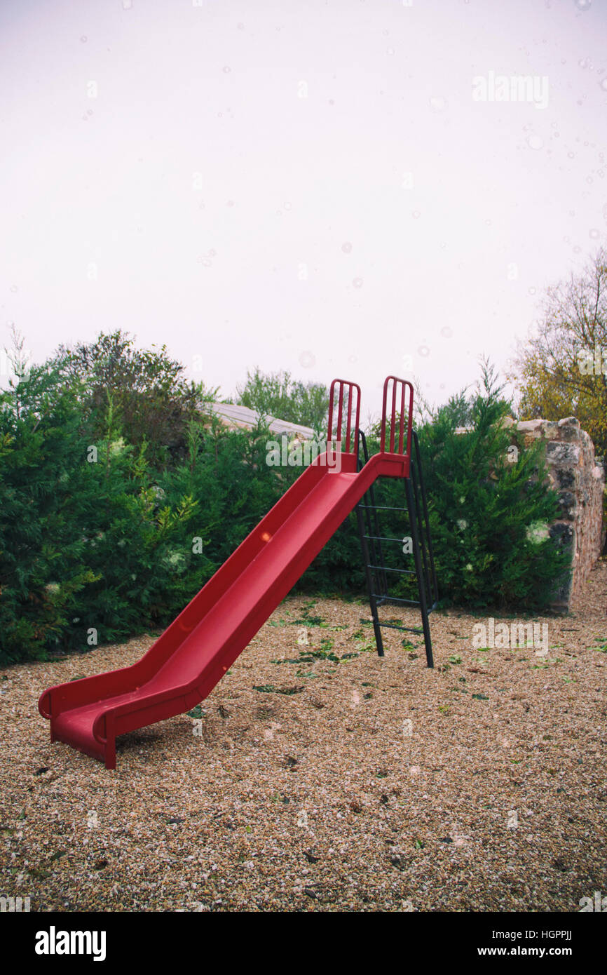 Red slide in a park Stock Photo - Alamy