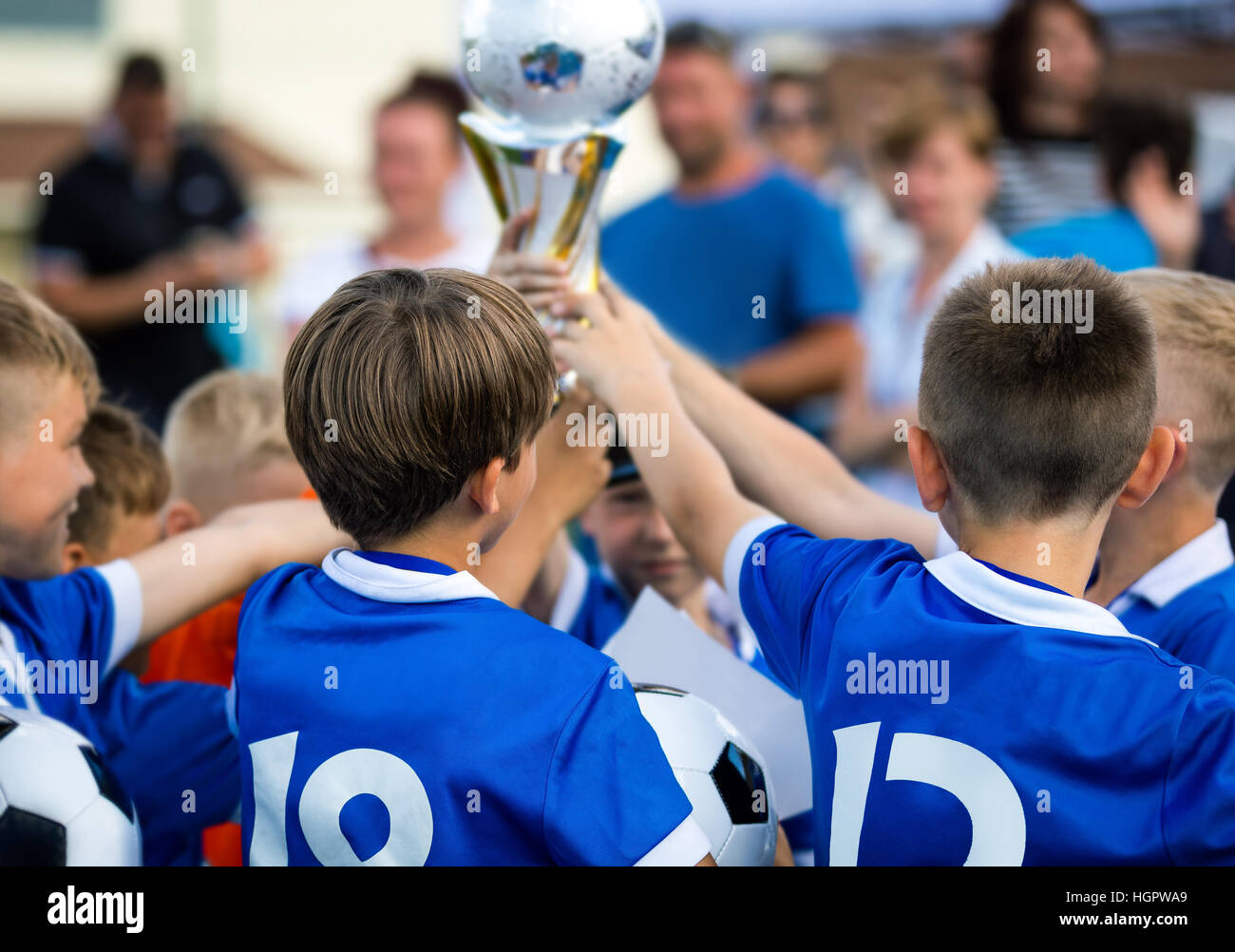 Young Soccer Players Holding Trophy. Children Soccer Football Champions. Boys Celebrating Soccer ...