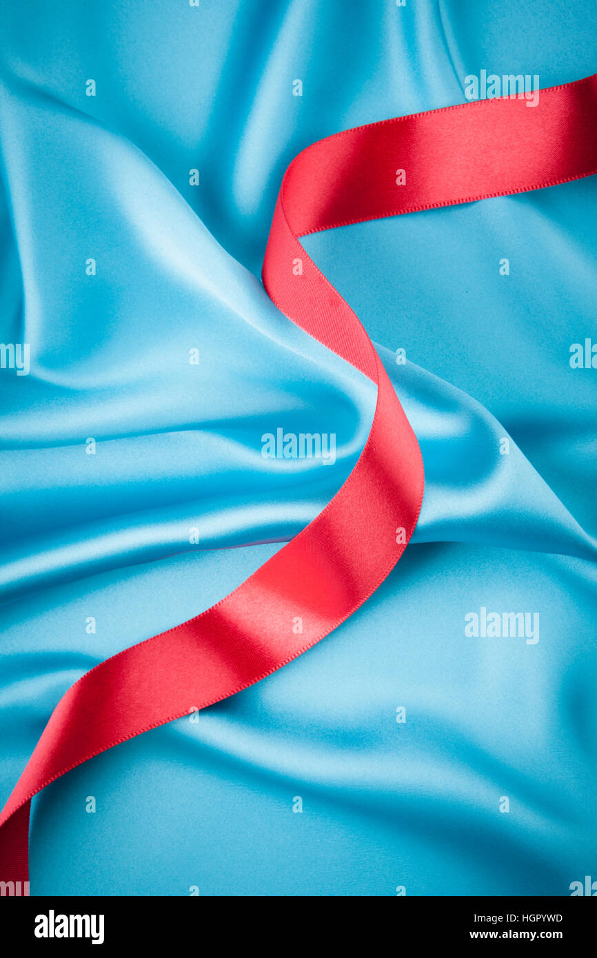 Close up of rwd ribbon and blue wrinkled silk Stock Photo - Alamy