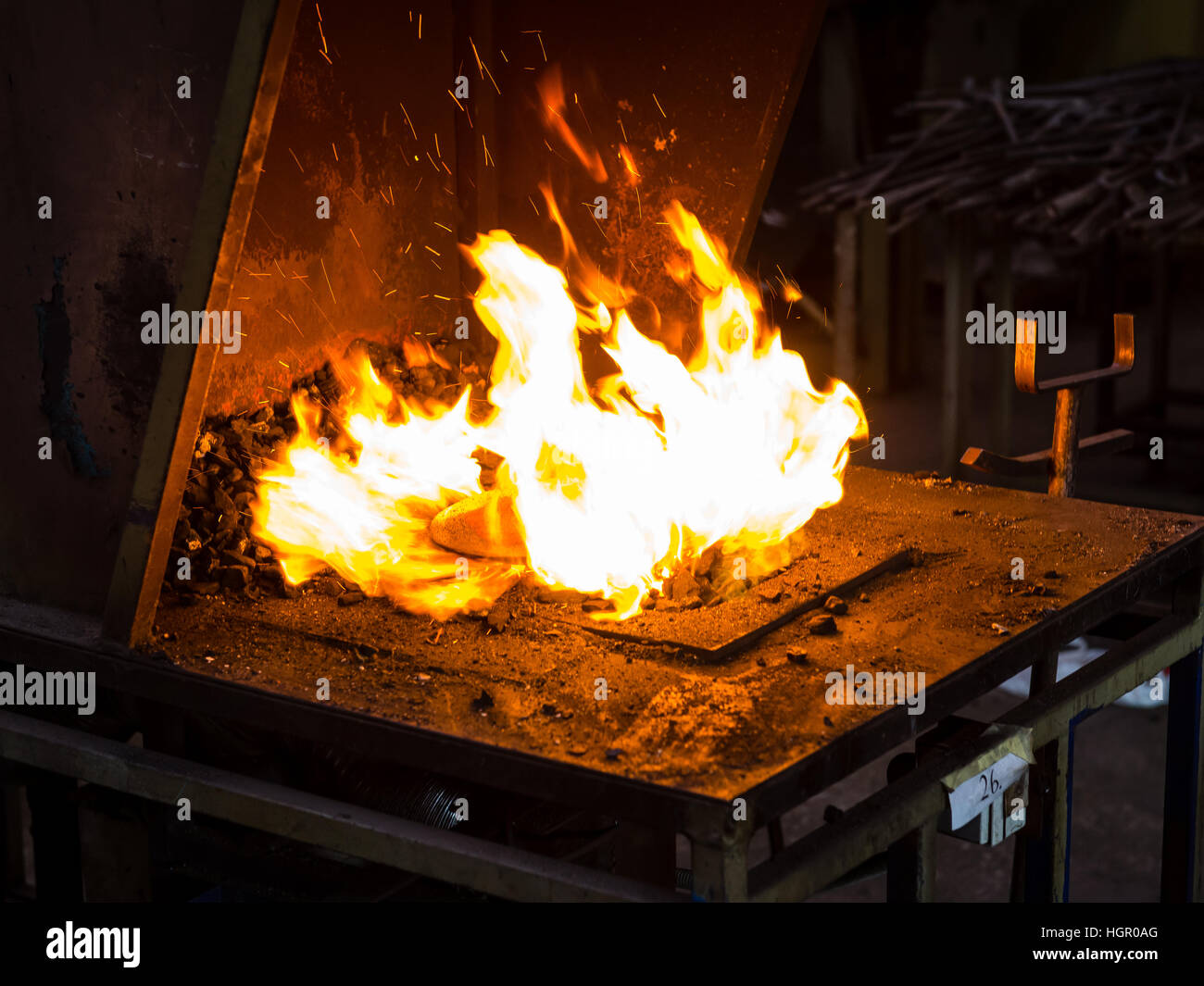 The blacksmith making flames in smithy with spark fireworks Stock Photo ...
