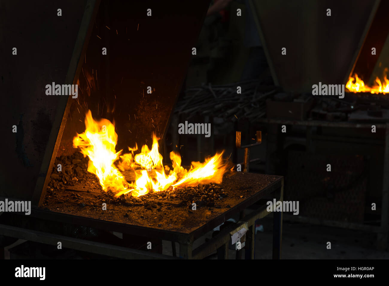 The blacksmith making flames in smithy with spark fireworks Stock Photo ...
