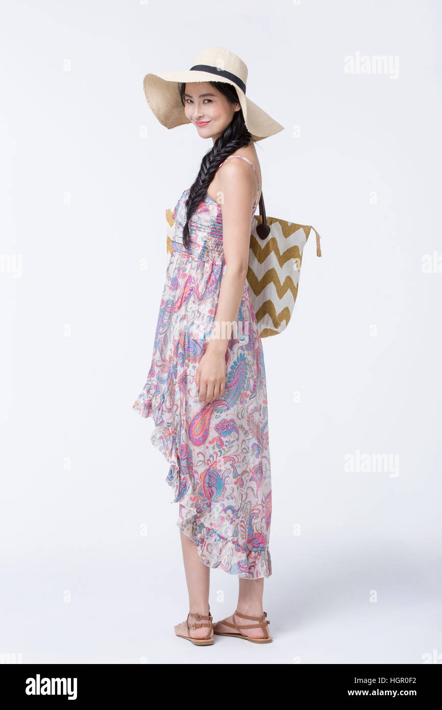 Back of young smiling woman in summer dress standing looking back Stock ...