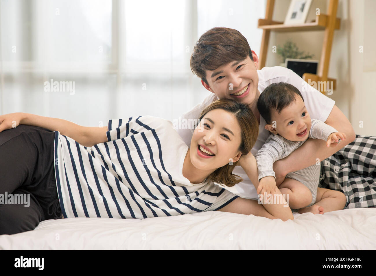 Harmonious family with a baby son Stock Photo - Alamy